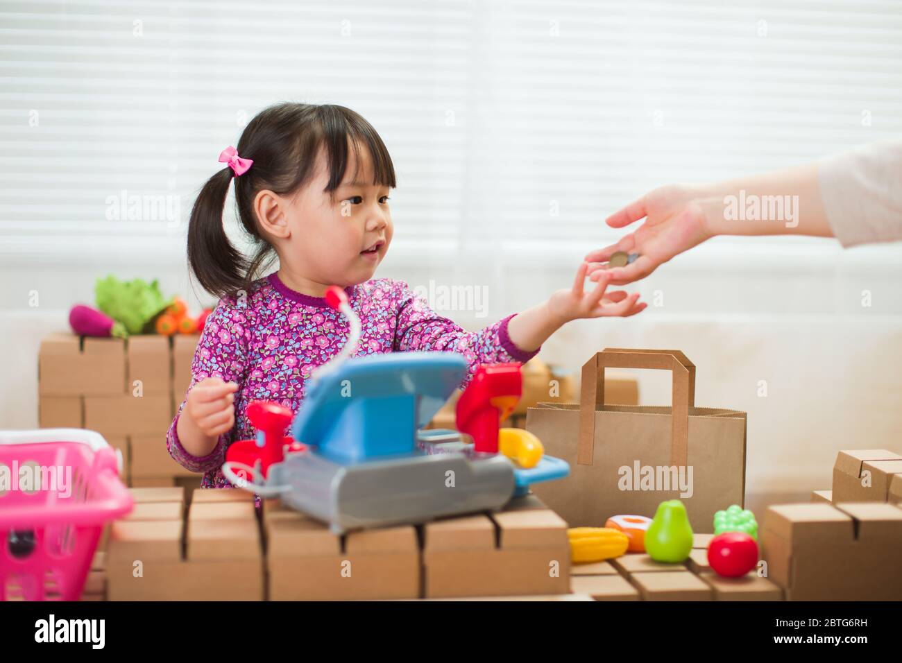 toddler girl pretend play sweet shop keeper at home Stock Photo - Alamy