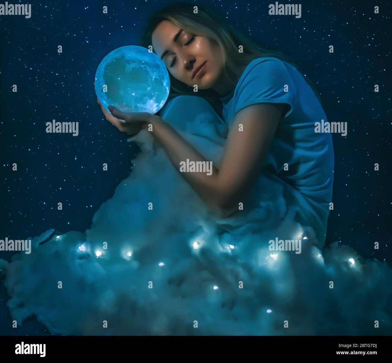 Young pretty woman with the full moon and clouds on the starry blue ...