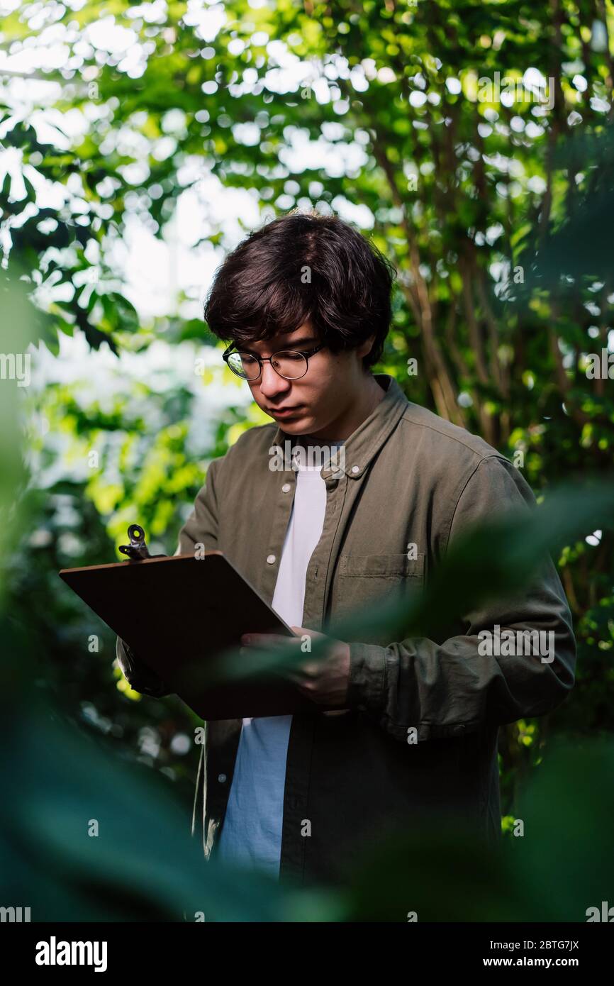 Nature protection concept. Male scientist carefully studies his data ...