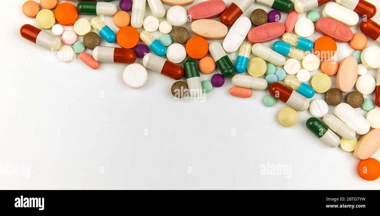 Panoramic different colorful medication and pills from above on a white ...