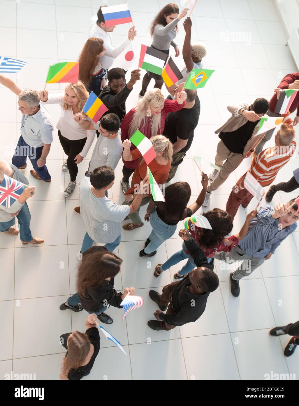 large group of people raising their national flags Stock Photo - Alamy