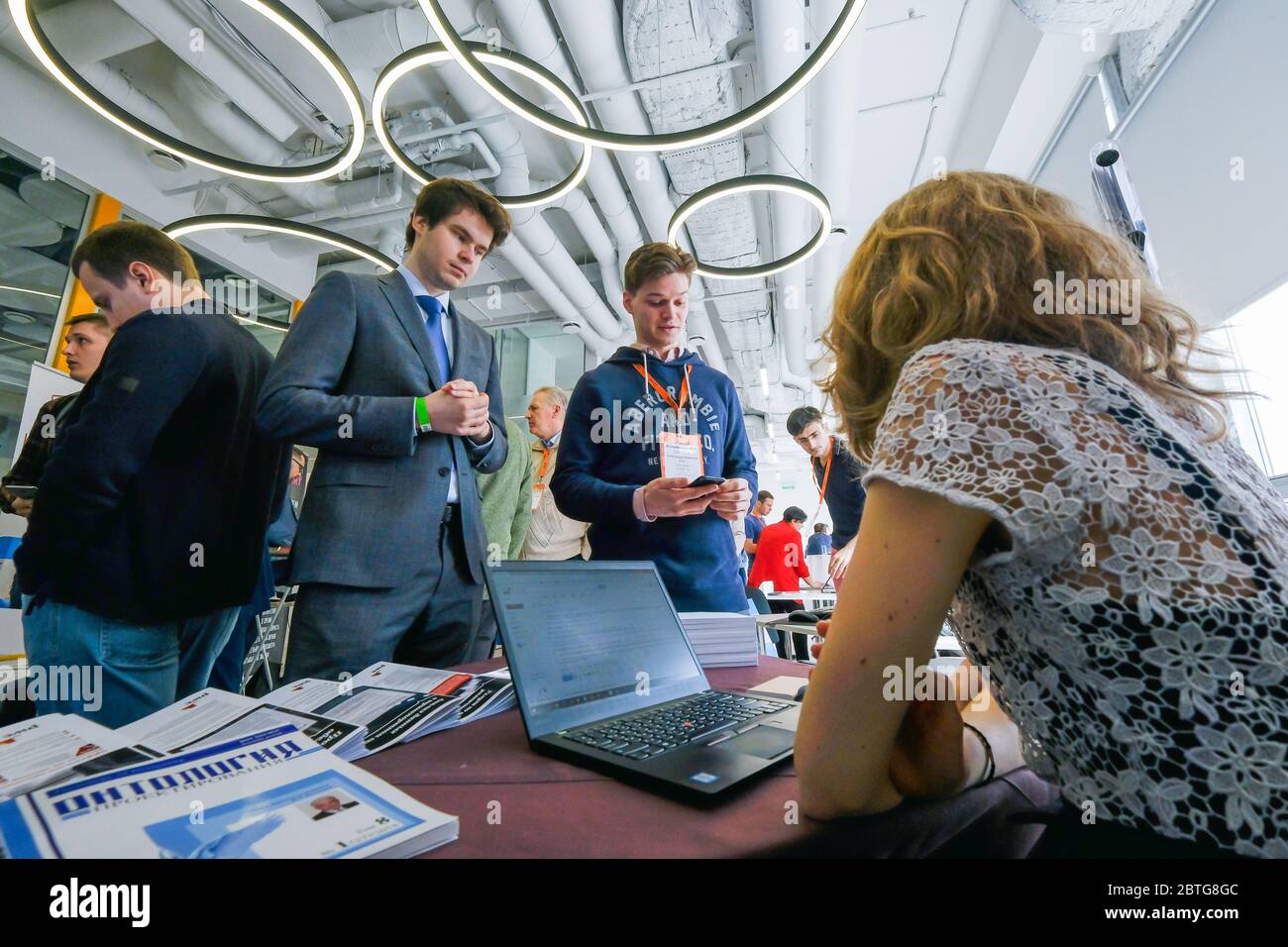 Conference visitors converse at hall Stock Photo - Alamy