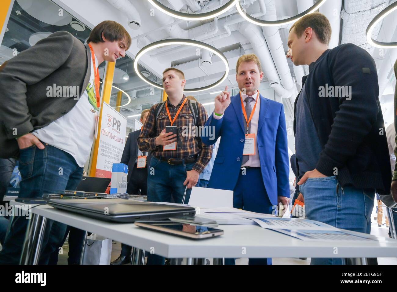 Conference visitors converse at hall Stock Photo - Alamy