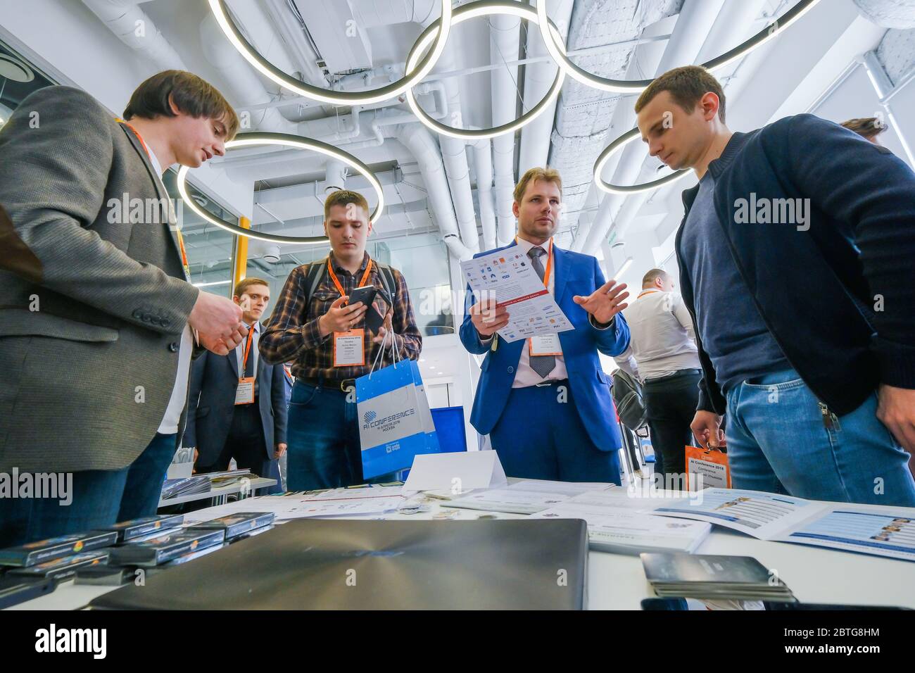 Conference visitors converse at hall Stock Photo - Alamy