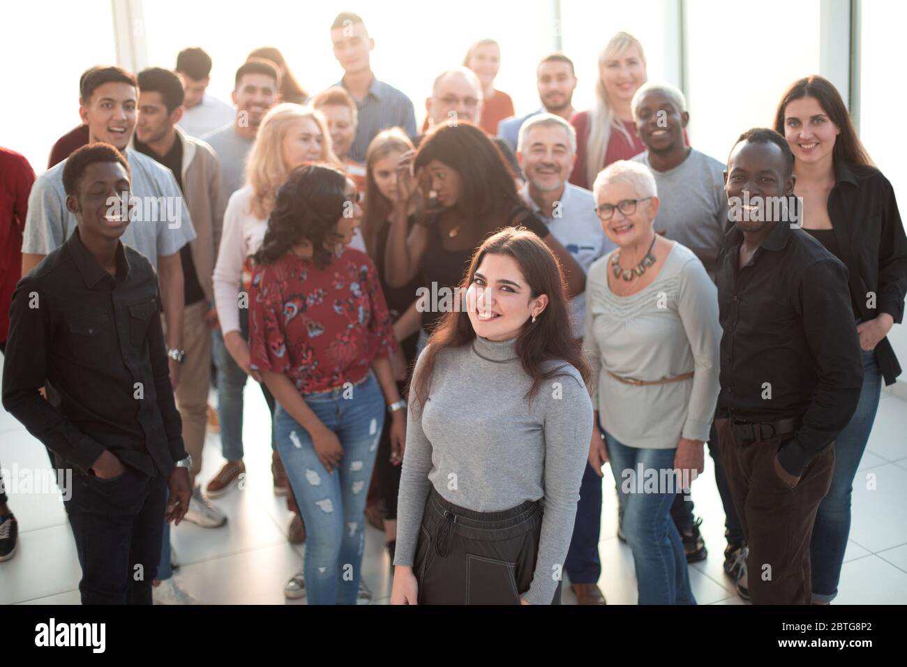 Young smiling executive standing in front of her business team Stock ...