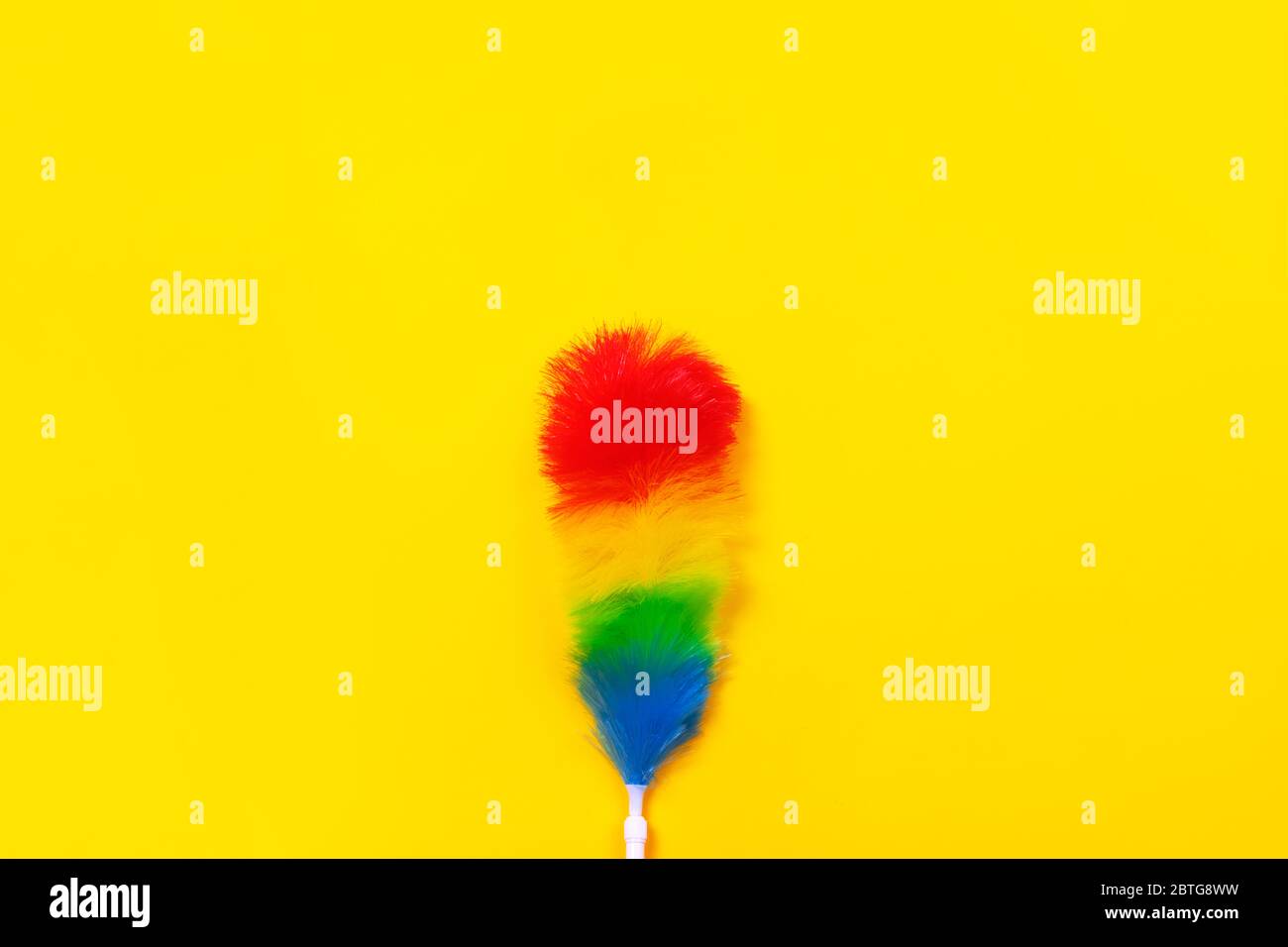Colorful feather duster on yellow background. Cleaning concept Stock ...