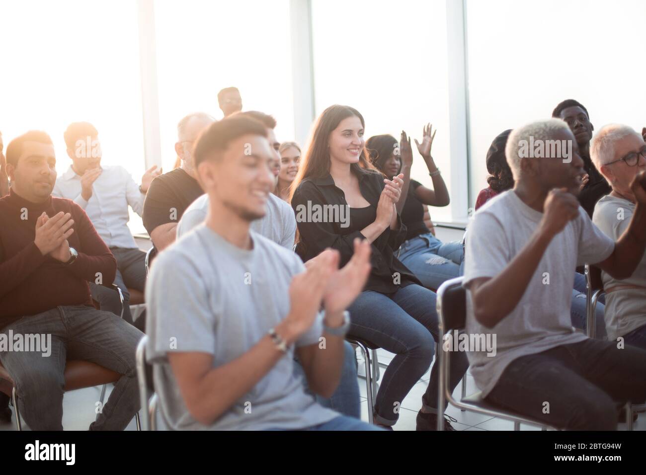 group of listeners supporting the speaker with applause Stock Photo - Alamy