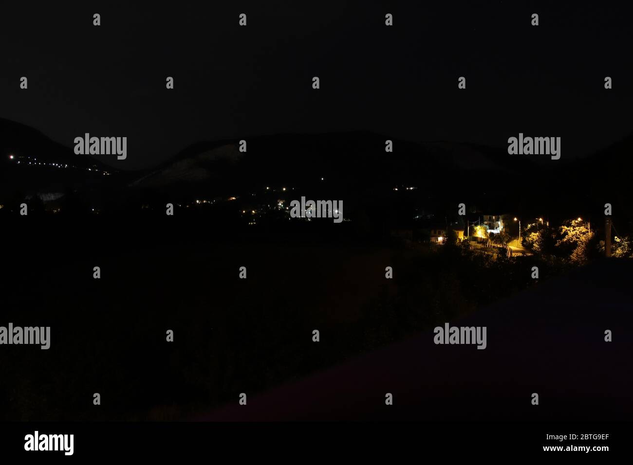 night landscape with street lights and mountains Stock Photo - Alamy