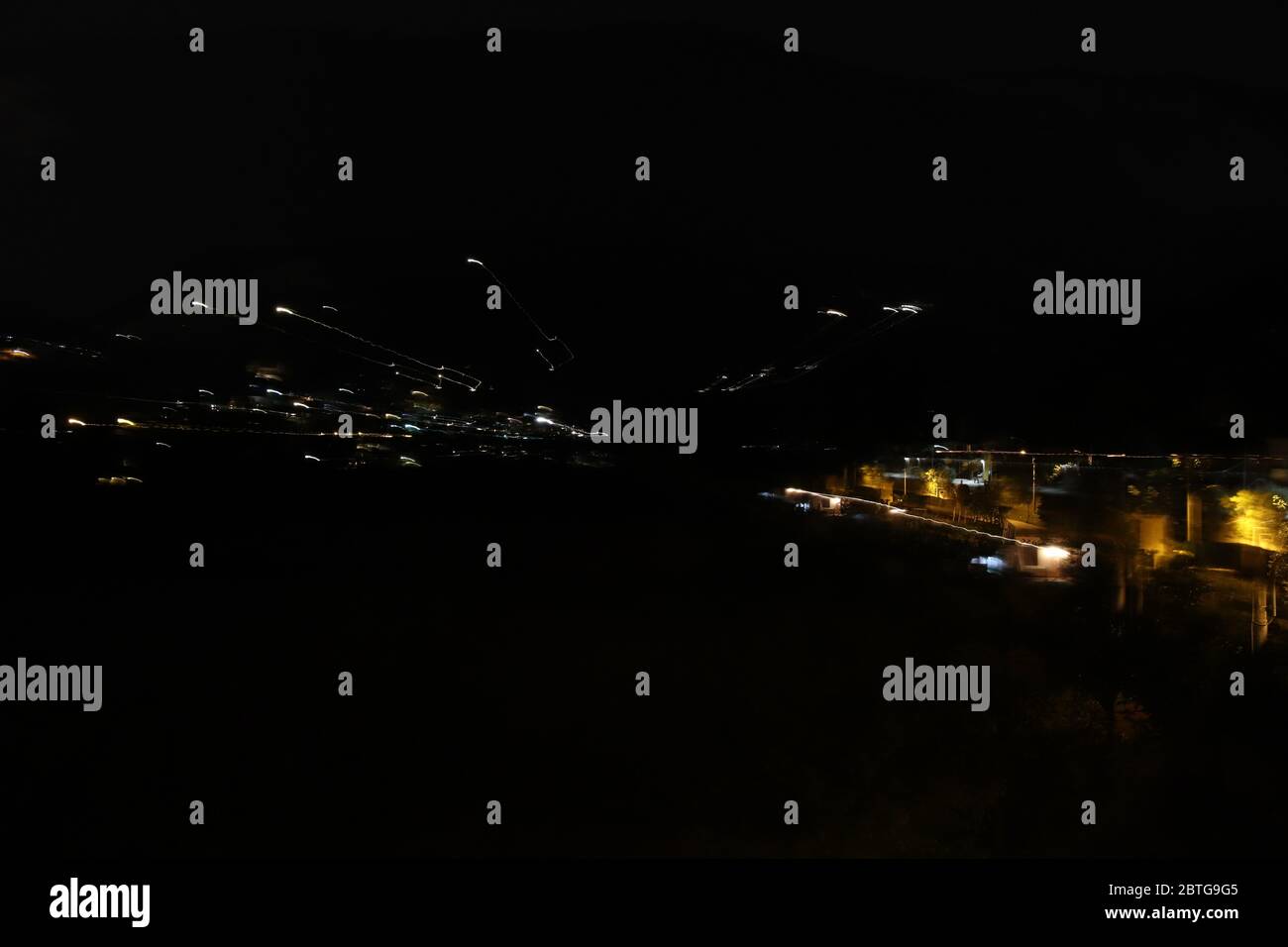 night landscape with street lights and mountains Stock Photo - Alamy
