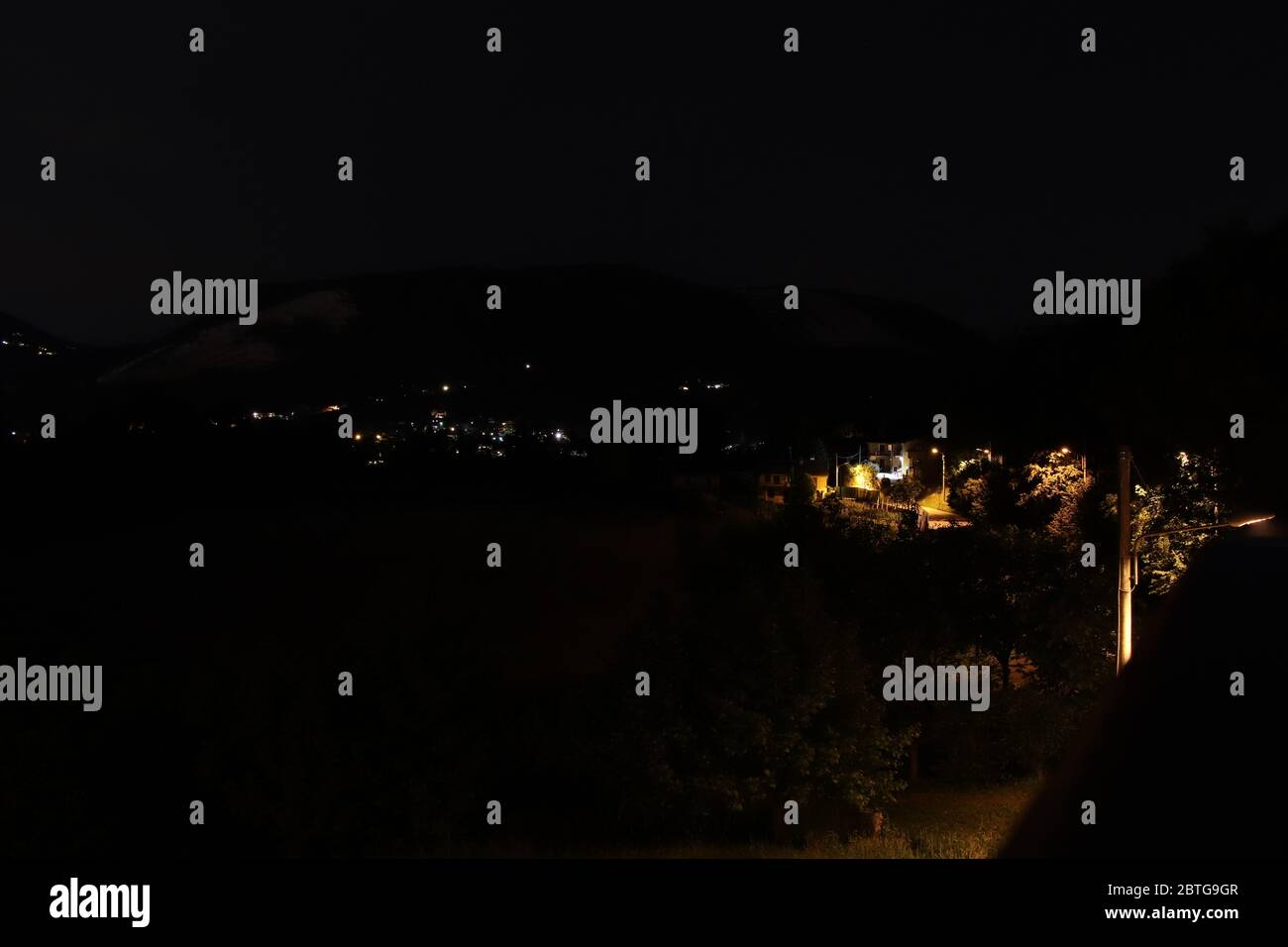 night landscape with street lights and mountains Stock Photo - Alamy