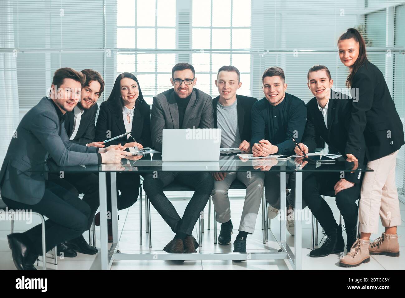 large business team sitting at an office Desk Stock Photo - Alamy