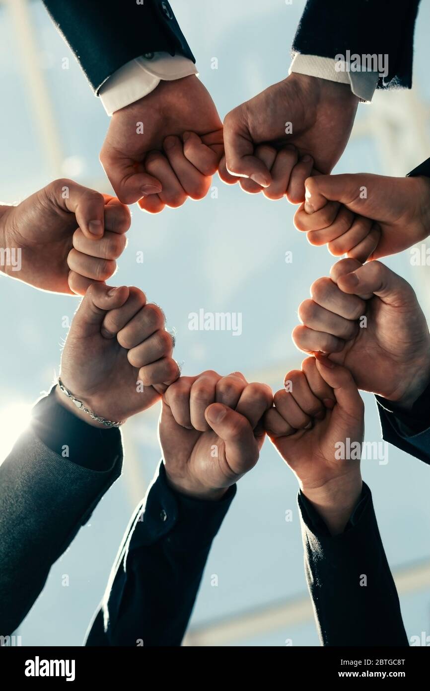 close up . ambitious business team standing in a circle Stock Photo - Alamy