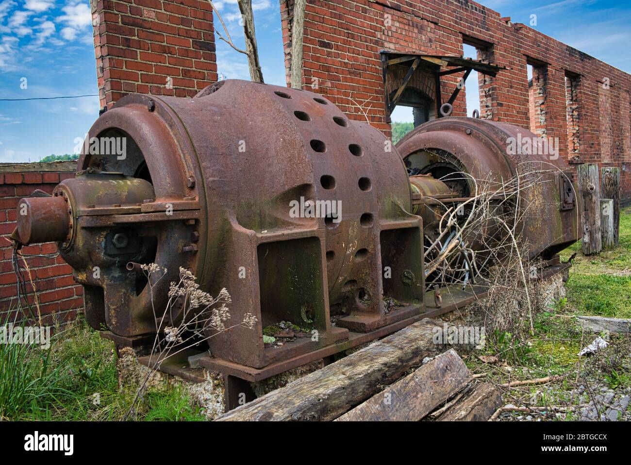 Generators rusting away in front of an abandoned building Stock Photo ...