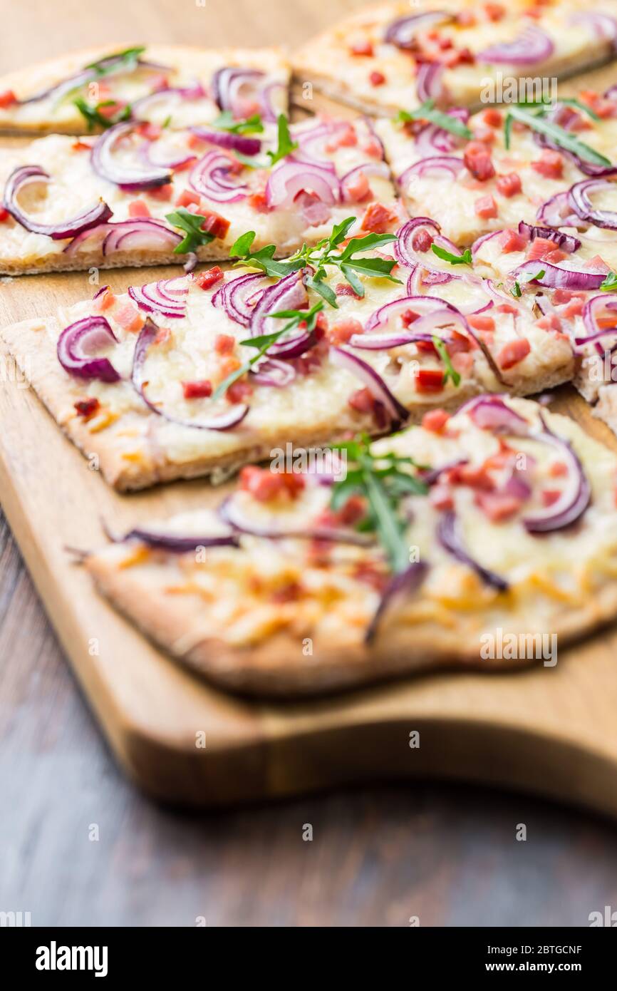 Traditional French dish tarte flambee cream cheese, bacon and onions ...