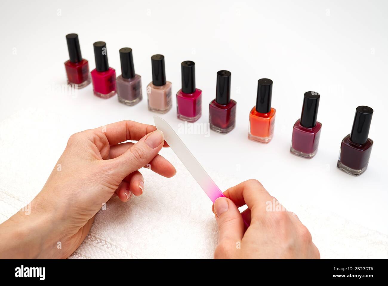 woman filing her finger at home. female polishes her nails to herself ...