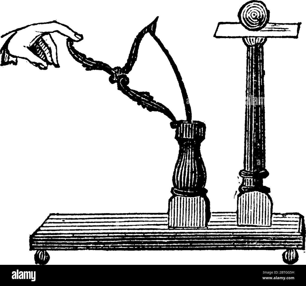 An experimental set-up with a short pillar, ball, card and a steel ...