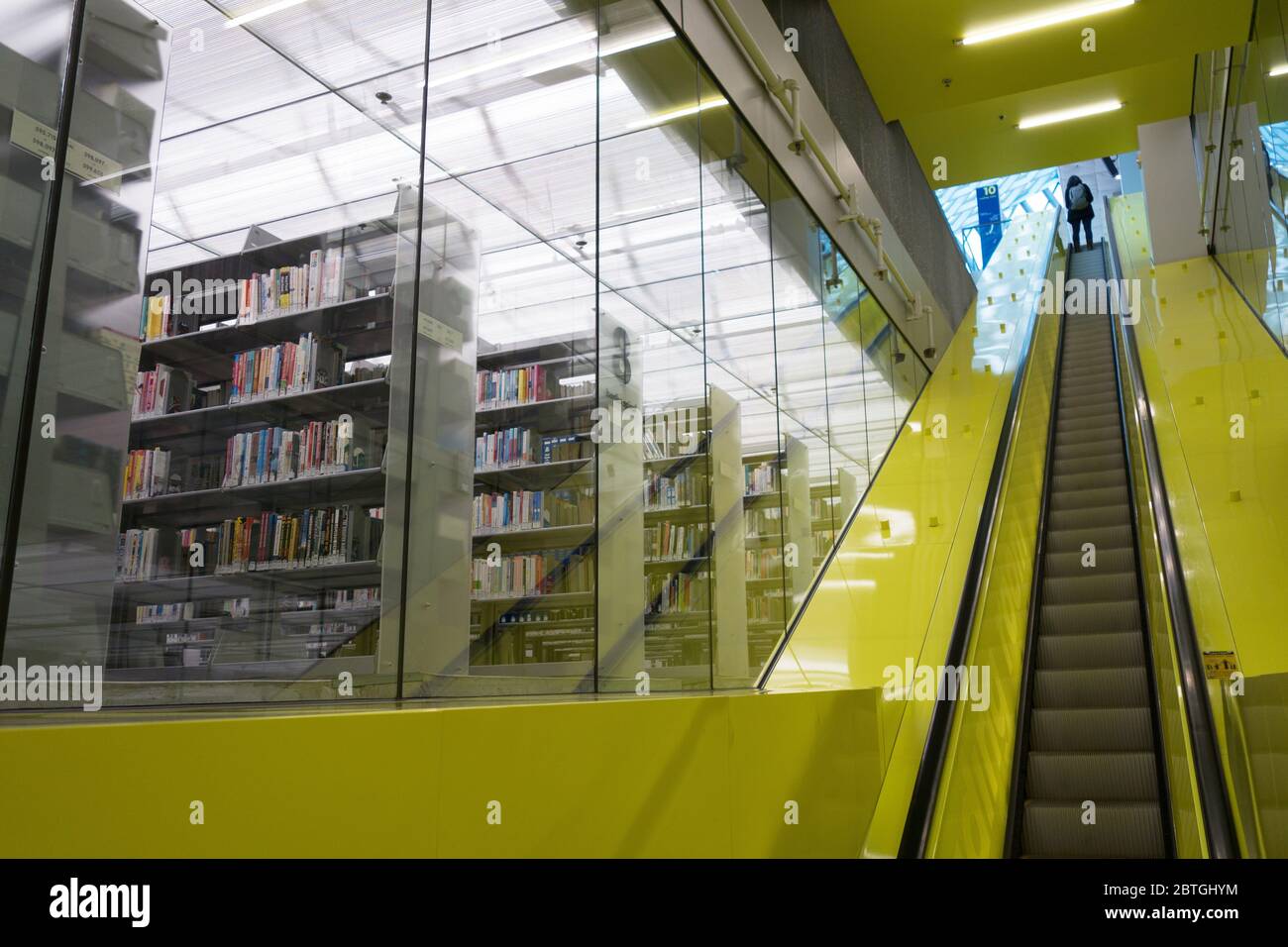 A person riding an escalator at The Seattle Public Library, Central ...