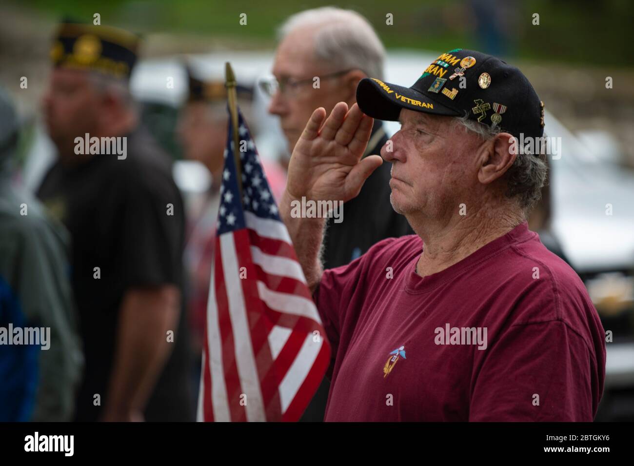 Manhattan, Kansas, USA. 25th May, 2020. Veteran, CHUCK HEINZ, salutes ...
