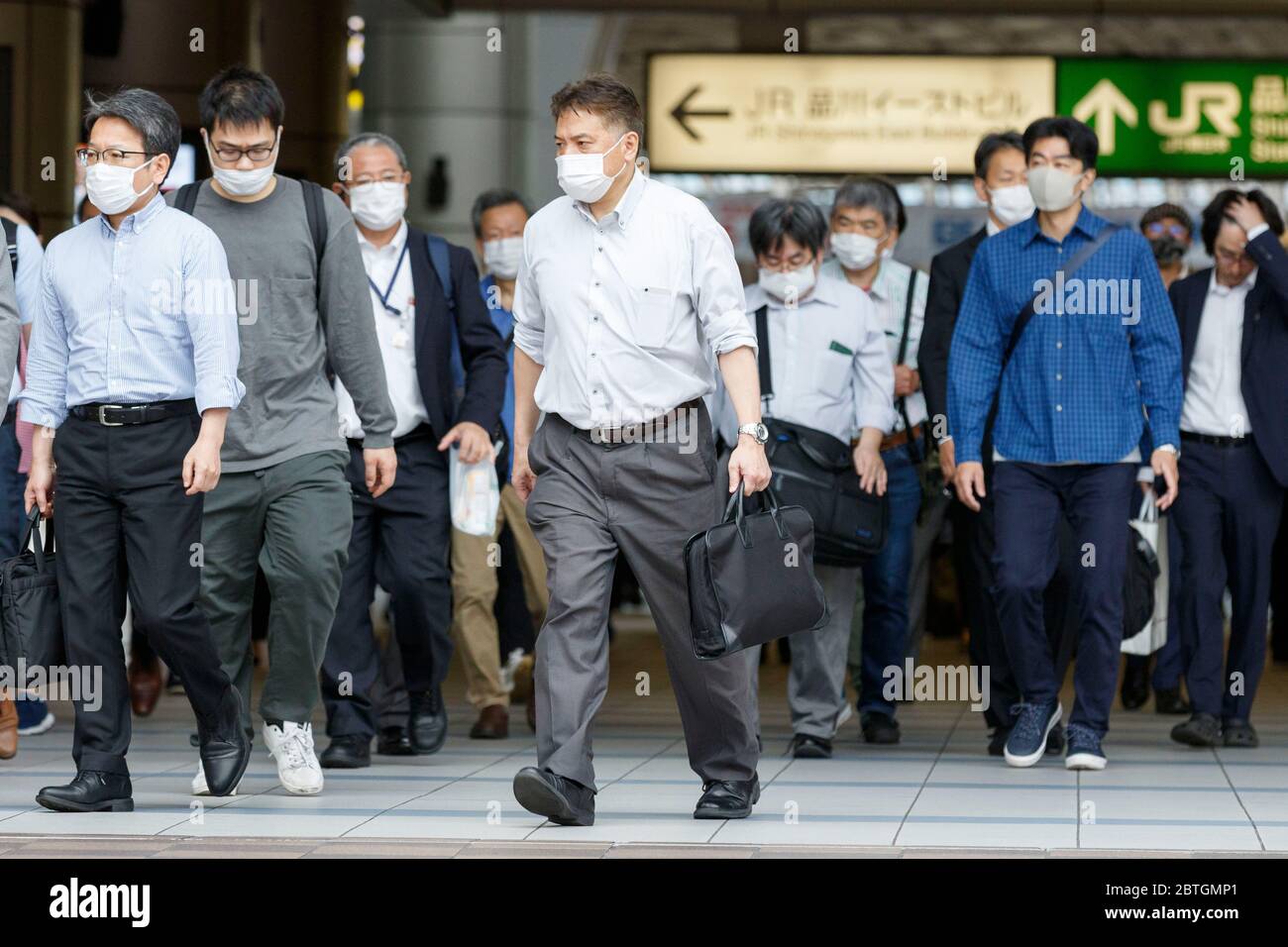 Tokyo, Japan. 26th May, 2020. Commuters wearing face masks walk from ...
