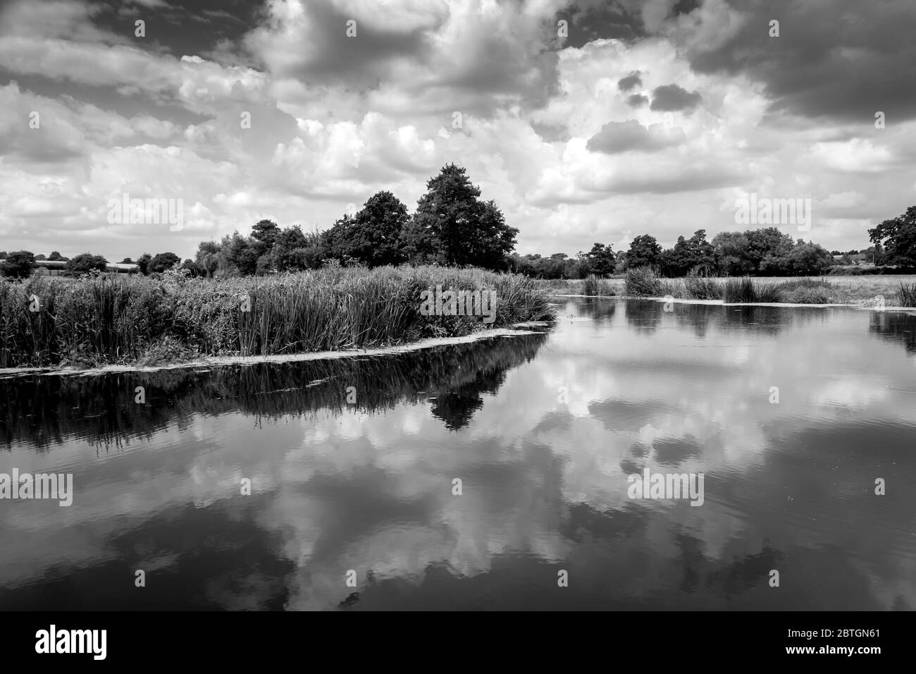 the river stour at fiddleford mill with clouds and reflections in river ...