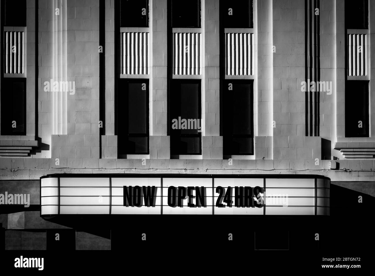 a building's open 24 hours sign Stock Photo - Alamy