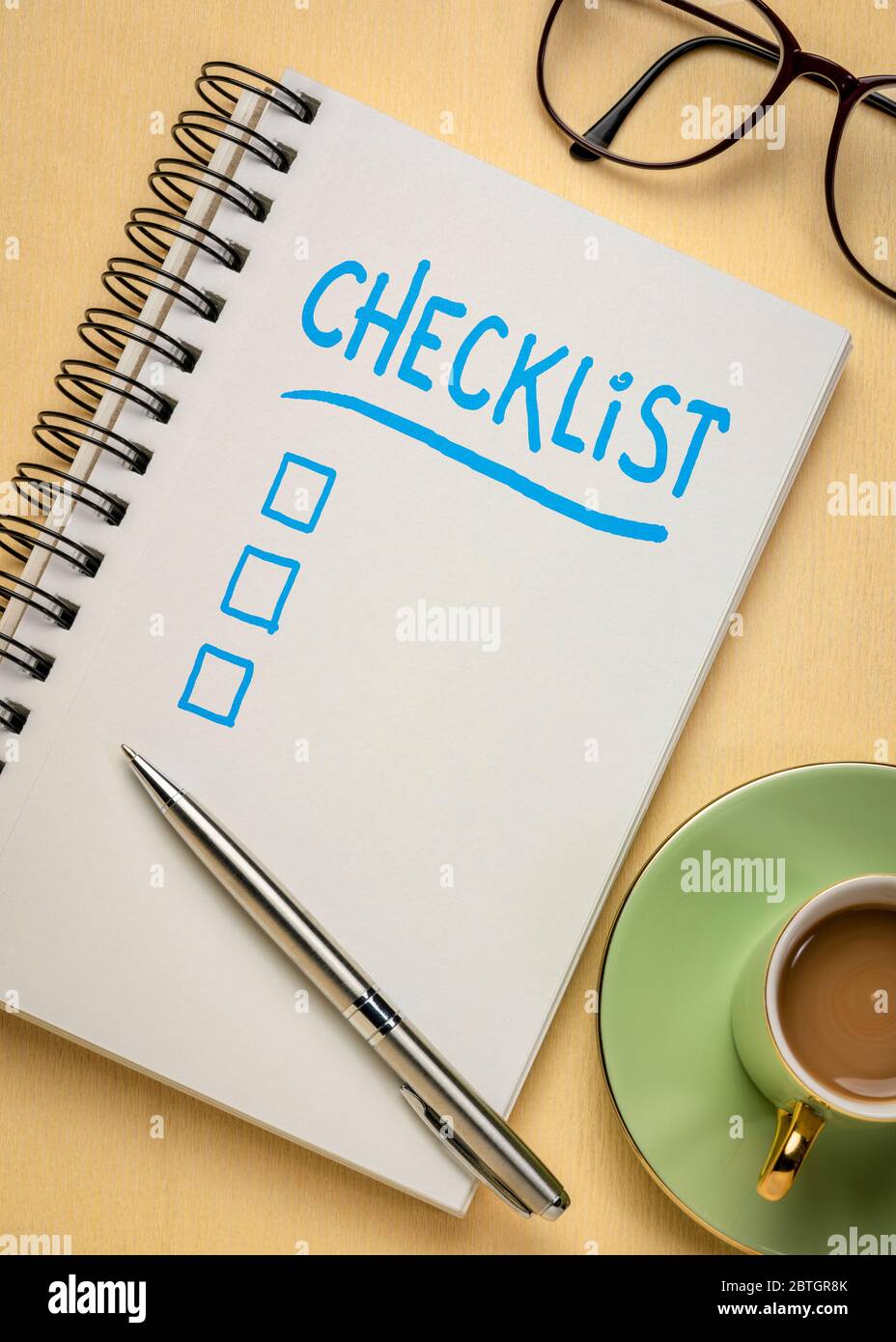 checklist - handwriting in a spiral notebook with coffee, operation ...