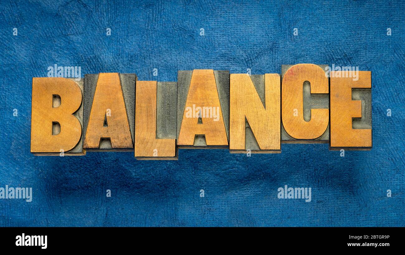balance word in vintage wood type against blue handmade bark paper ...