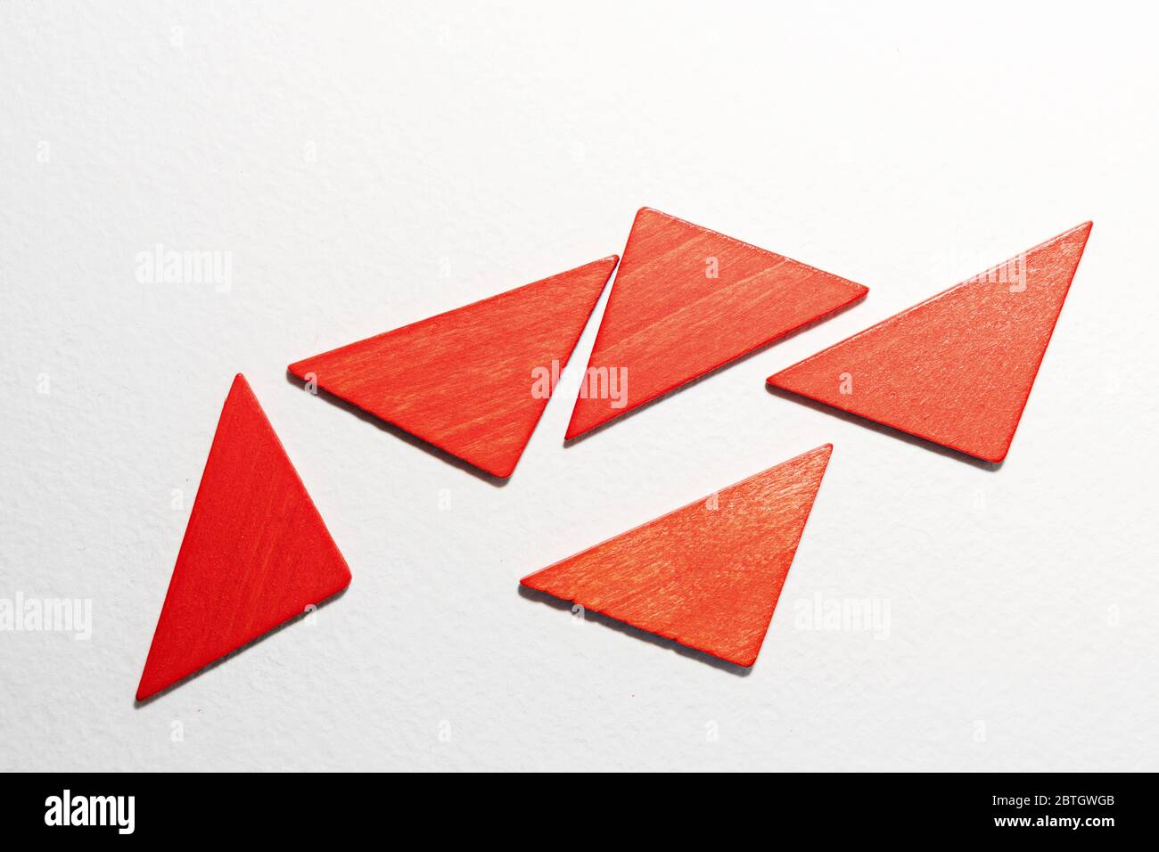 Different colorful triangles wooden on white background. Geometric ...