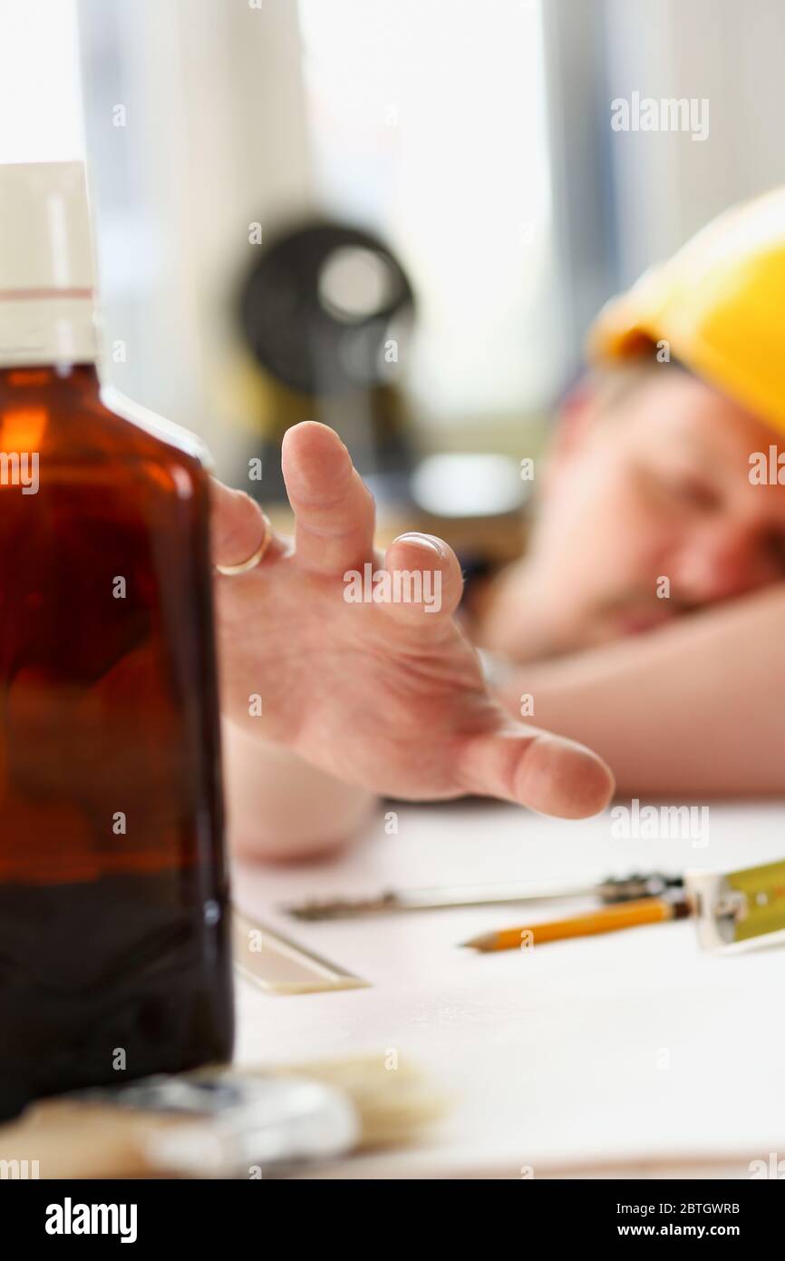 Arm of drunken worker in yellow helmet Stock Photo - Alamy