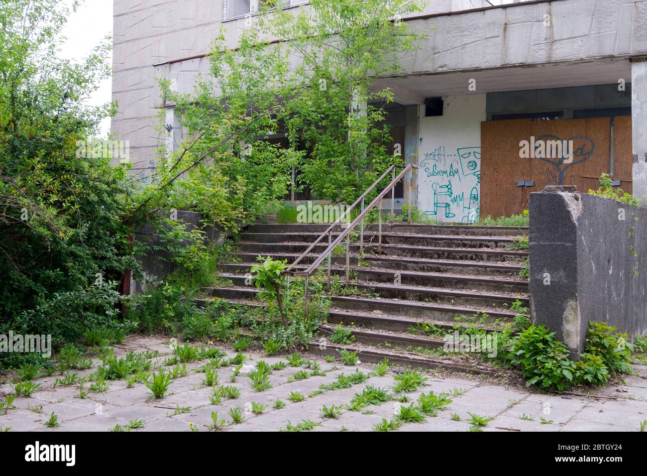 The overgrown entrance staircase of a closed, decaying USSR, Communist ...
