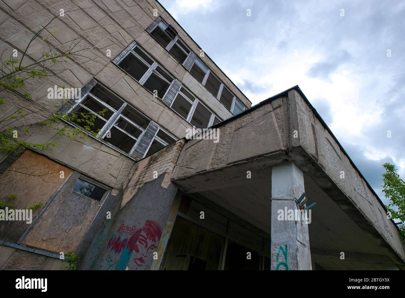 The looming entrance and broken windows of a closed, decaying USSR ...