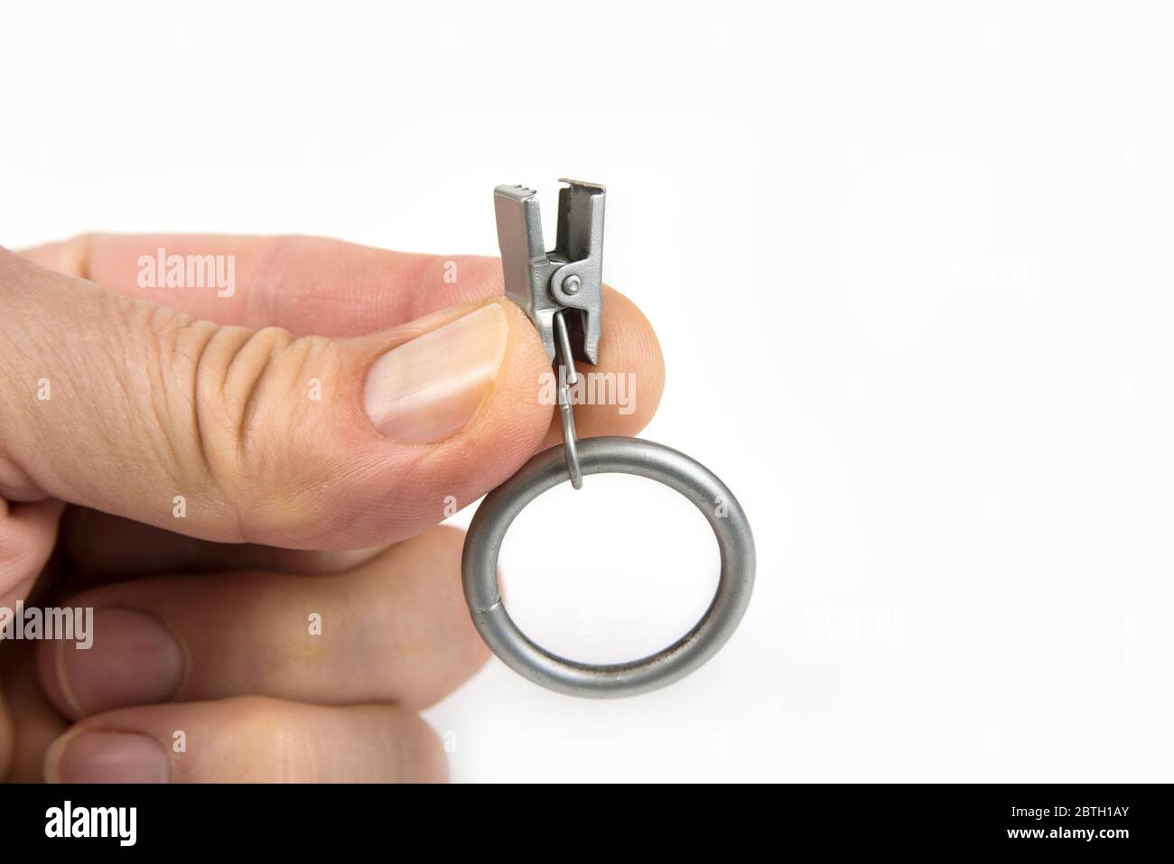 Metal curtain ring with clipper in a white background Stock Photo - Alamy