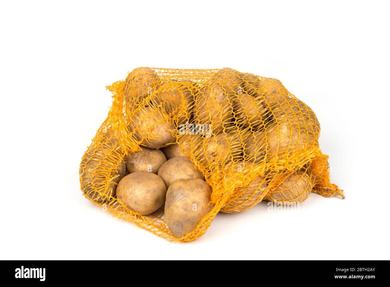 Potato in the mesh net bag on a white Stock Photo - Alamy