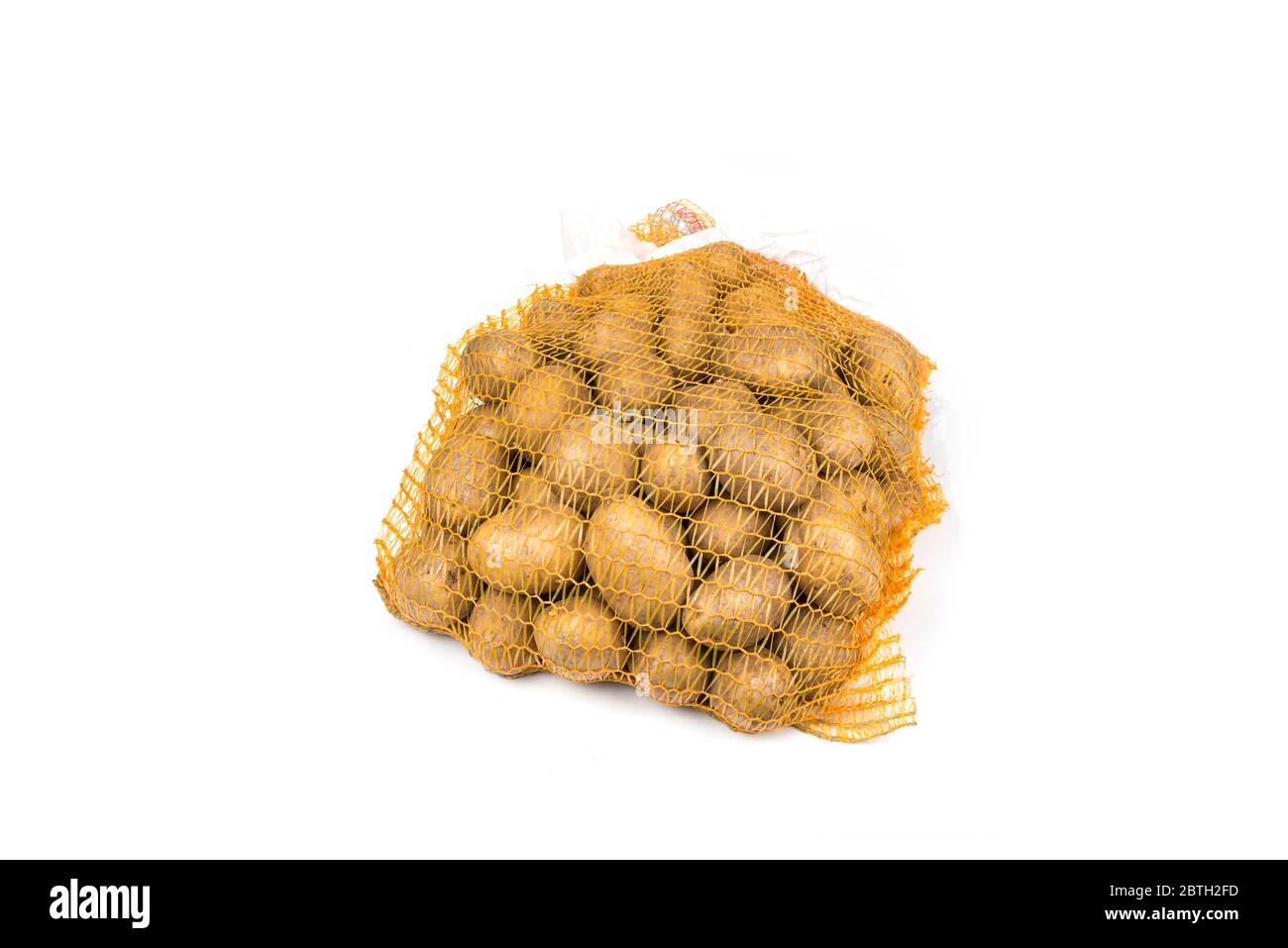 Potato in the mesh net bag on a white Stock Photo - Alamy