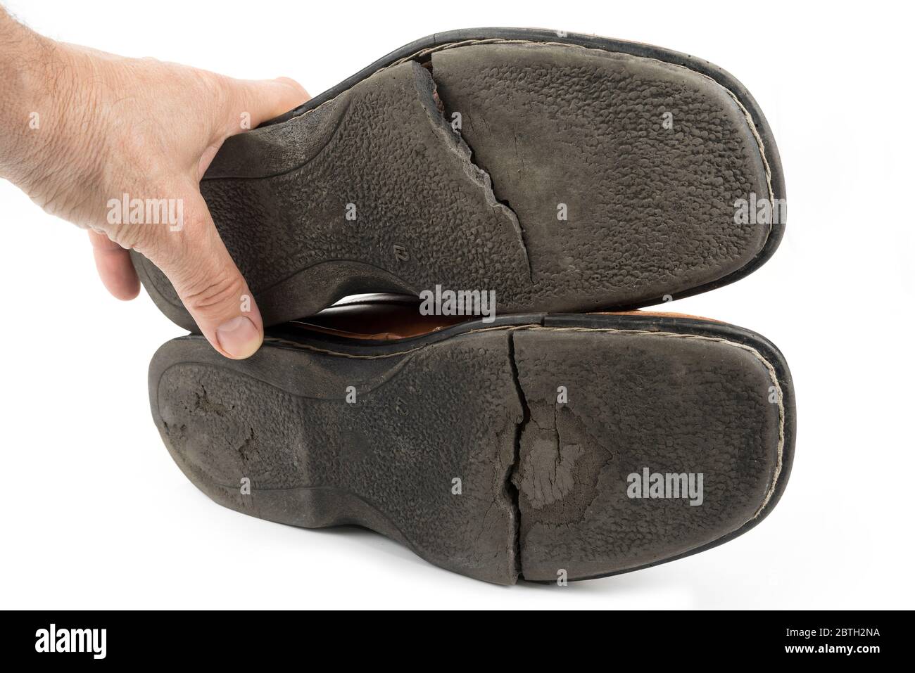 Torn leather shoes on a white background Stock Photo - Alamy