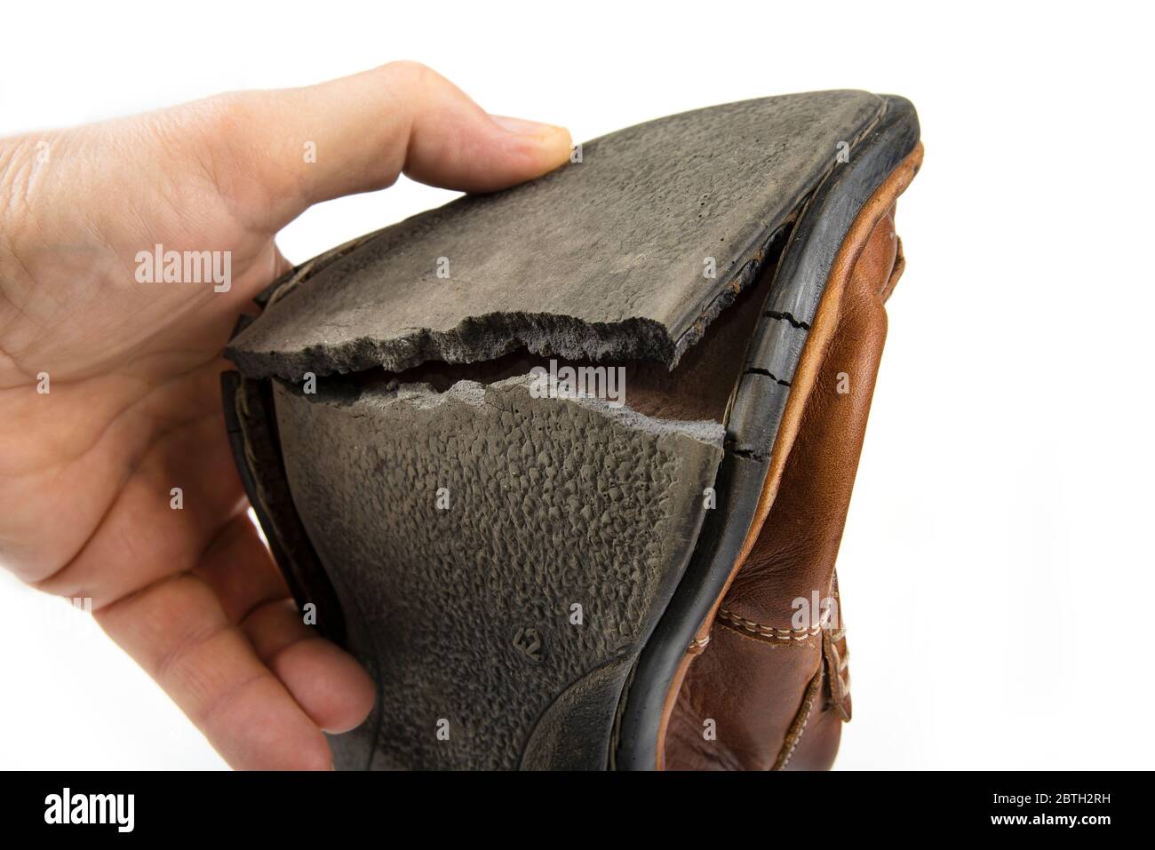 Torn leather shoes on a white background Stock Photo - Alamy