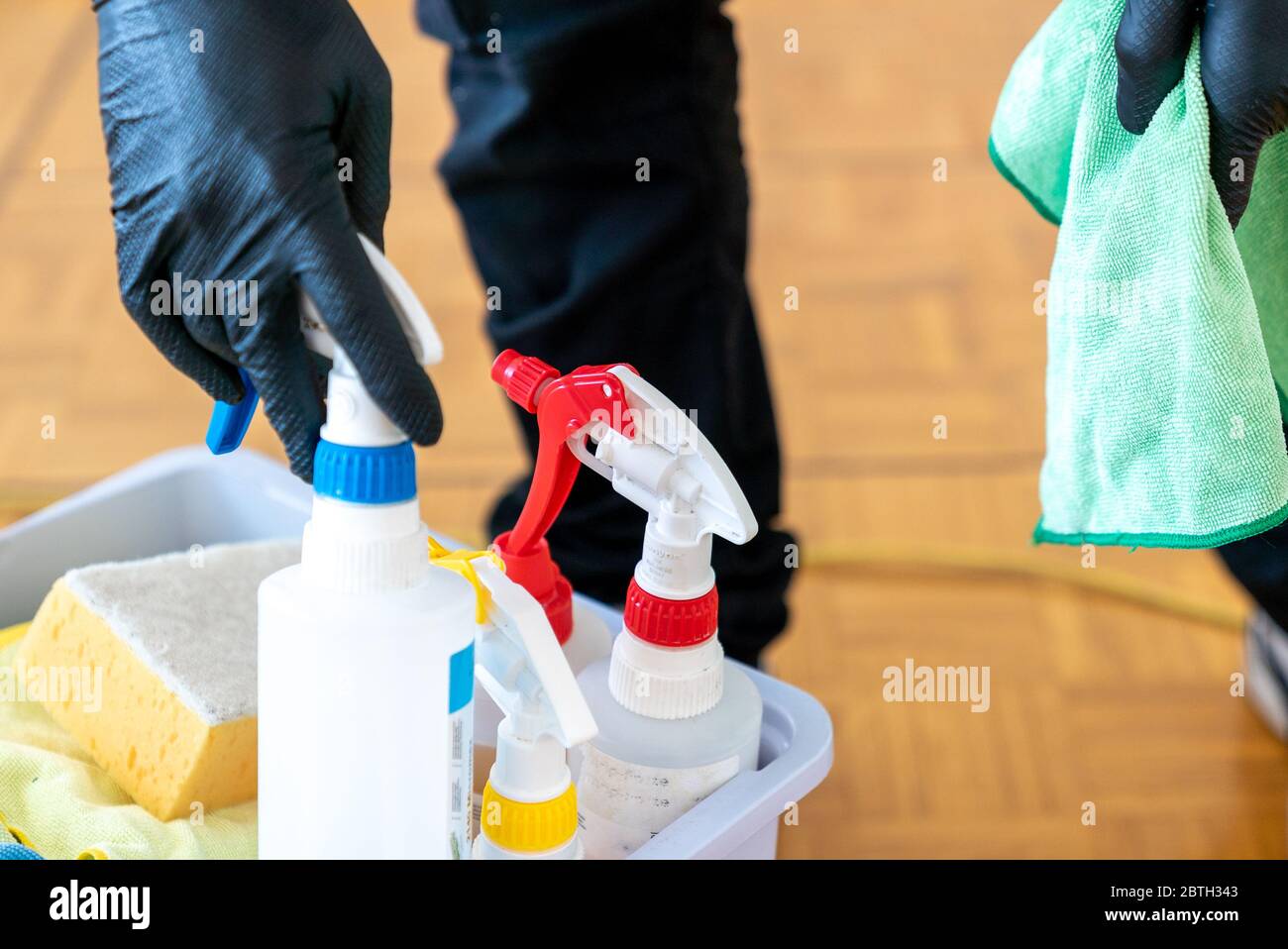 A professional window cleaner removing cleaning supplies from a bucket ...
