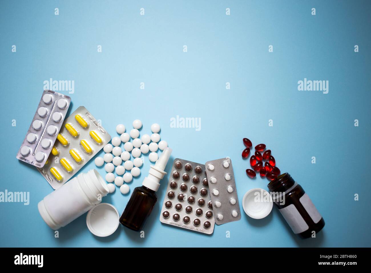 Different medications in containers and bottles, tablets and capsules ...