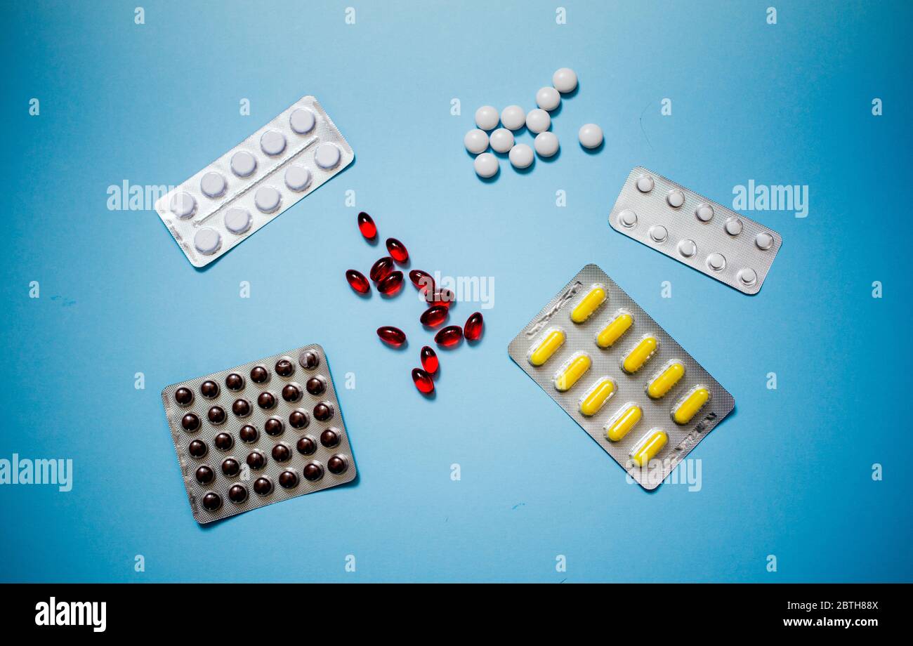 Different medications in containers and bottles, tablets and capsules ...