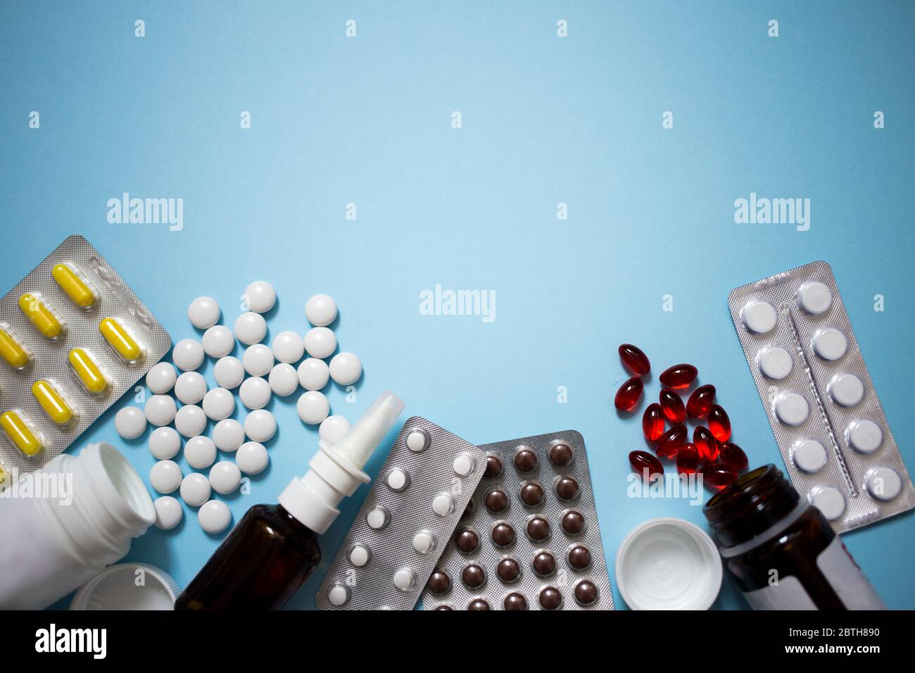 Different medications in containers and bottles, tablets and capsules ...