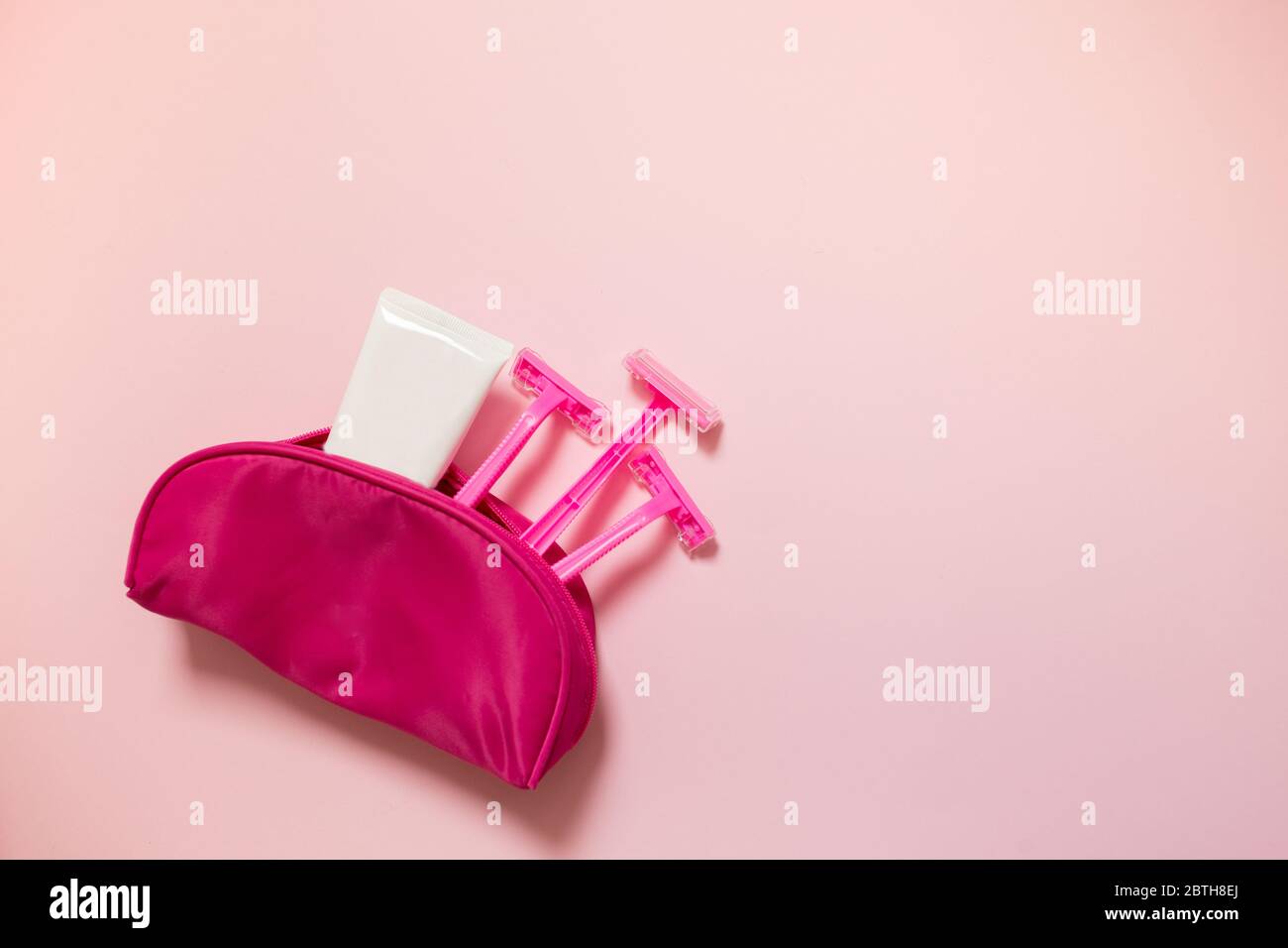 Pink razor blades and cream for a comfortable shaving for female on a ...