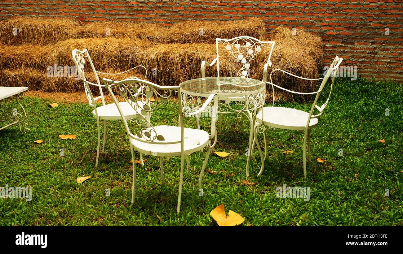White seat set on grass in a vintage farm Stock Photo - Alamy