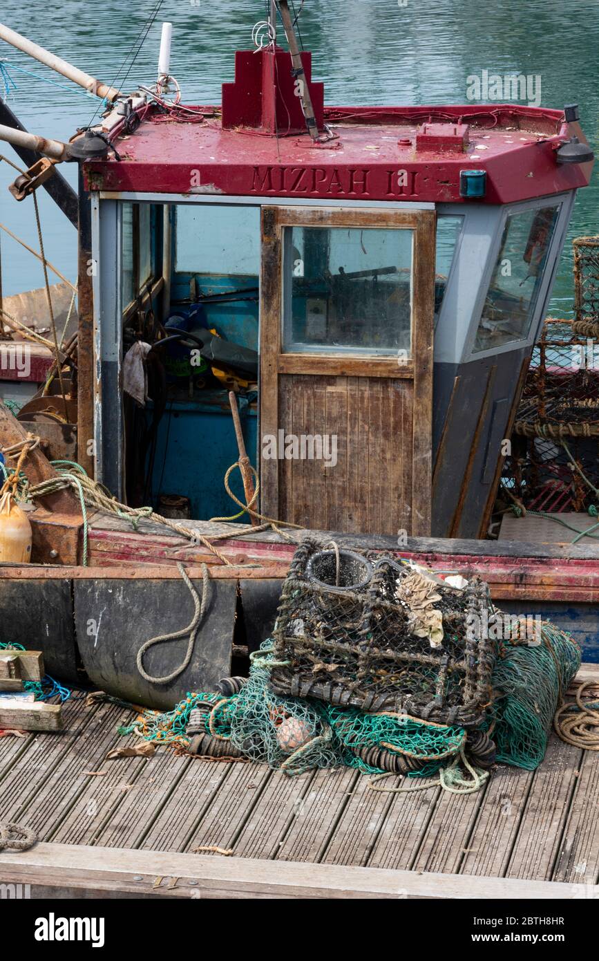 an old fashioned inshore trawler in docks at the harbour-side with ...