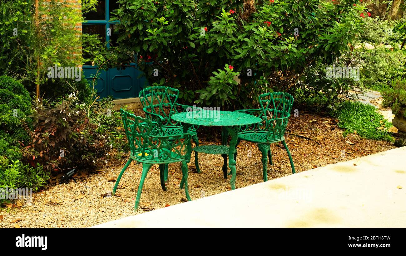 Green seat set in a garden Stock Photo - Alamy