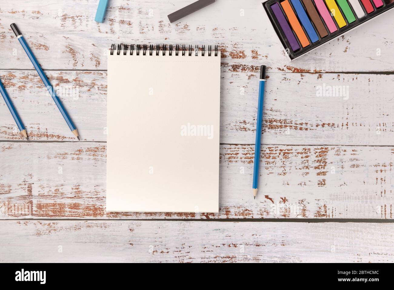 Learning painting concept, painting crayons and pencils on white wooden ...