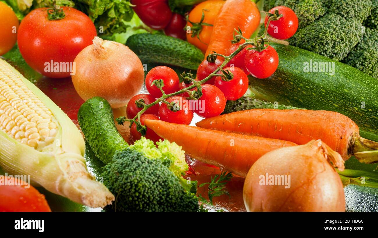 Closeup photo of wet fresh vegetables with water droplets lying on ...