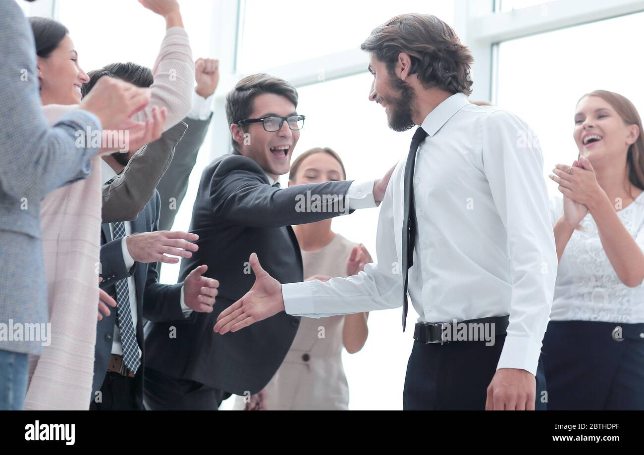 corporate group of employees congratulating each other on the victory ...