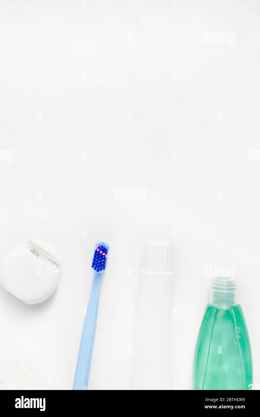 Teeth hygiene and oral dental care products on white marble table ...