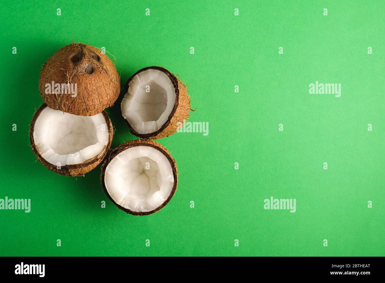 Coconut fruits on green plain background, abstract food tropical ...