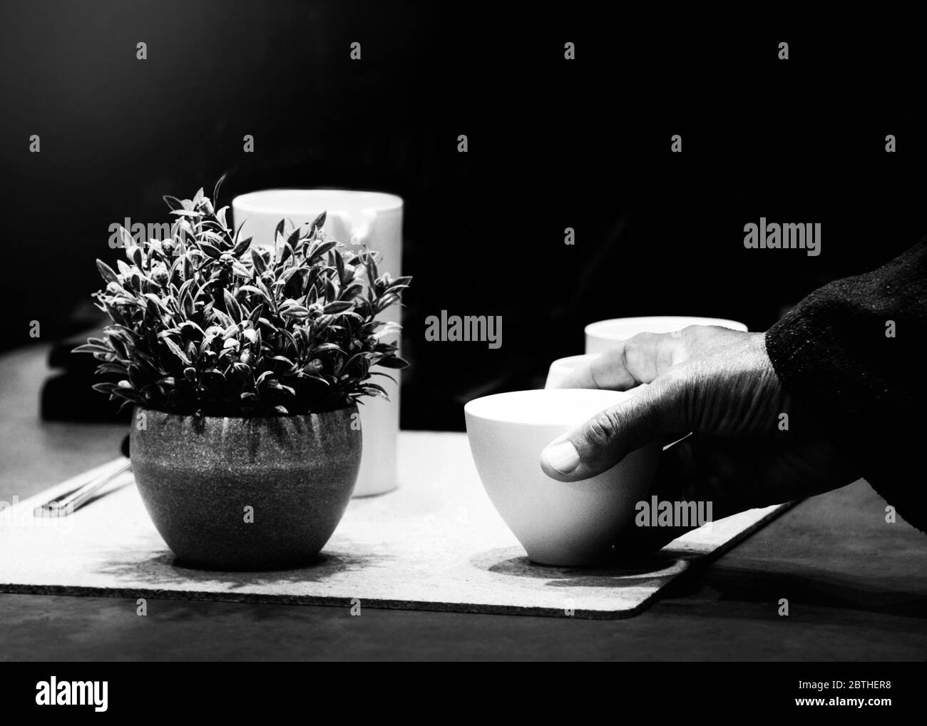 Hand and cup Black and White Stock Photos & Images - Alamy